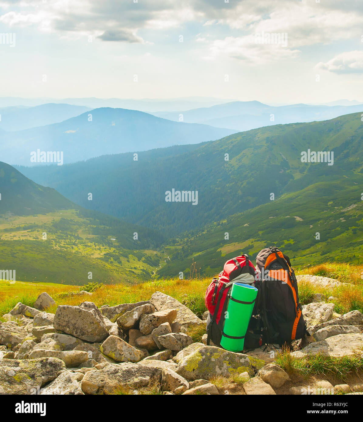 Two backpacks in mountains together Stock Photo - Alamy