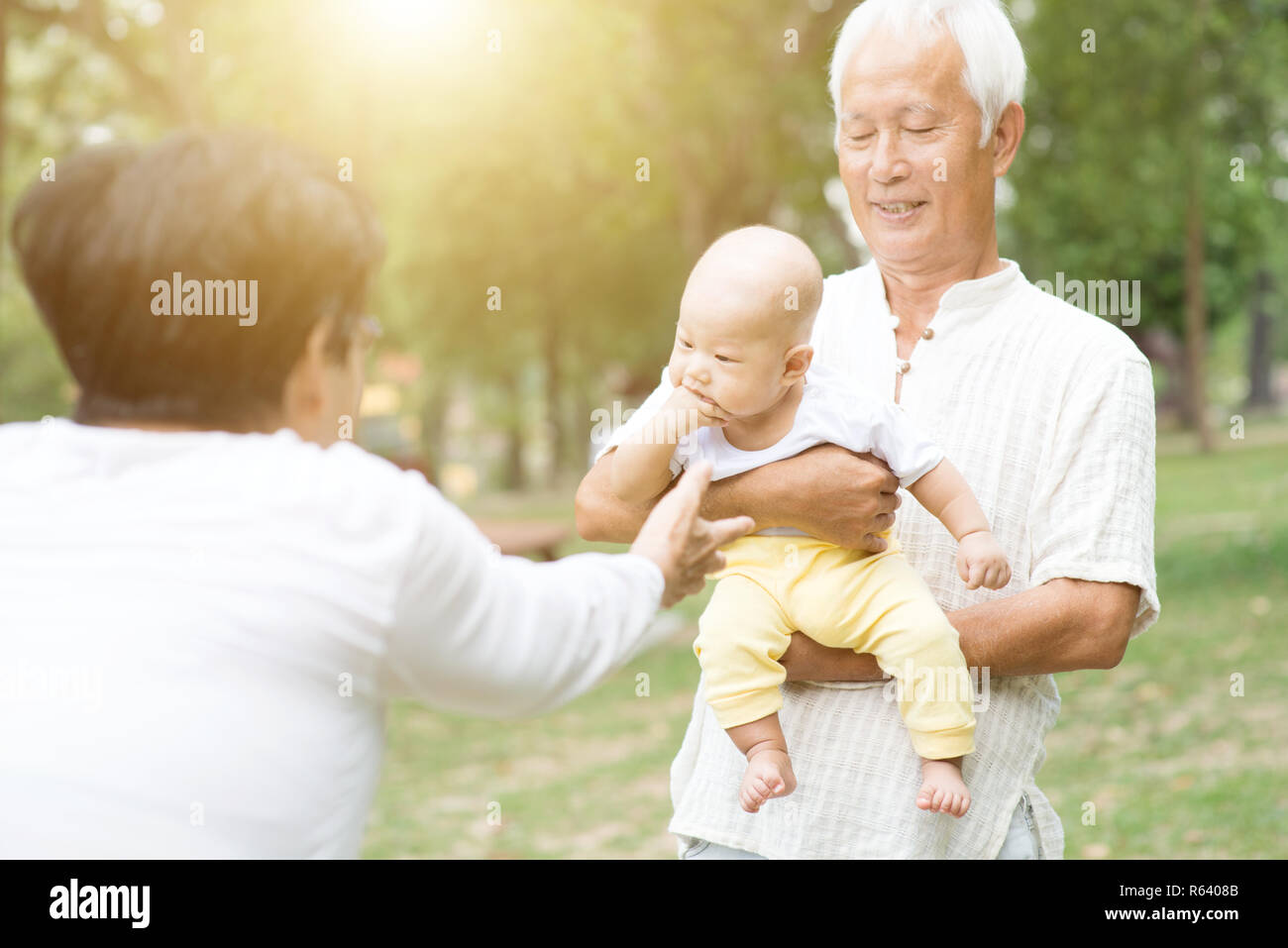 Grandfather holding newborn grandchild hi-res stock photography and ...