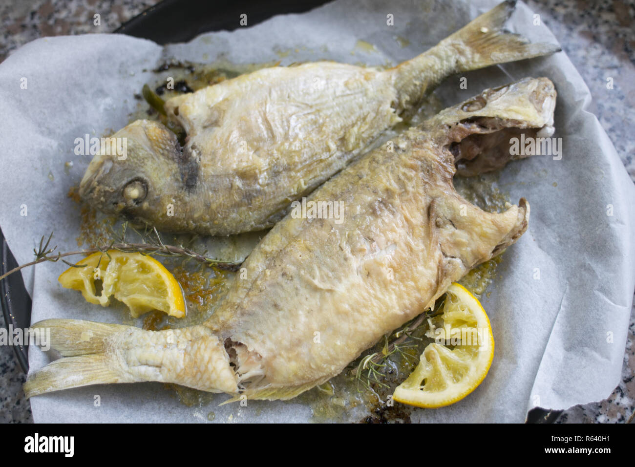 blue fish fry in a pan Stock Photo - Alamy
