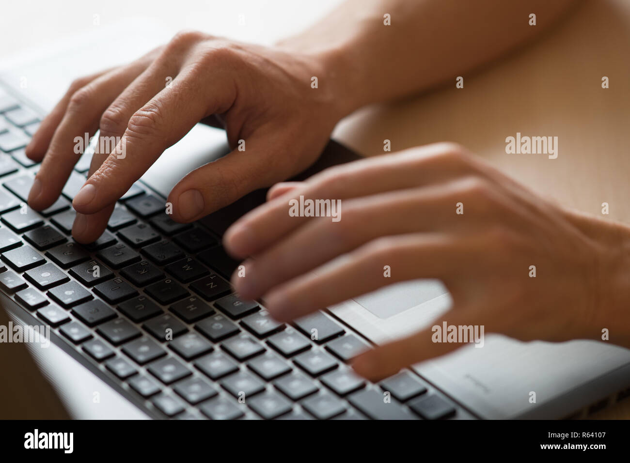 Men hands typing on a keyboard of laptop Stock Photo - Alamy