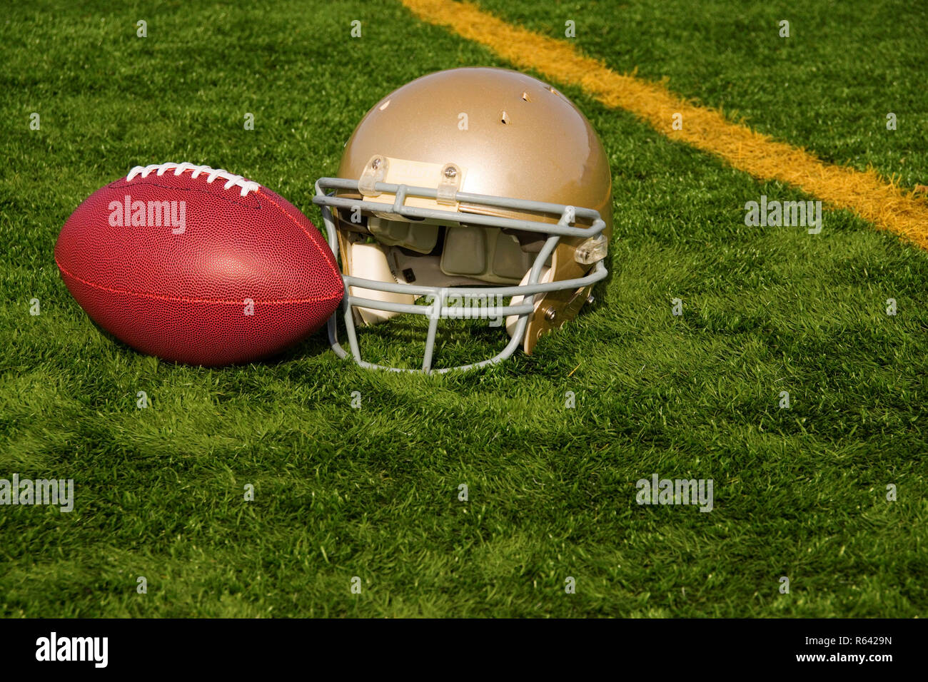 Football Helmet and Ball Near Goal Line Stock Photo - Alamy