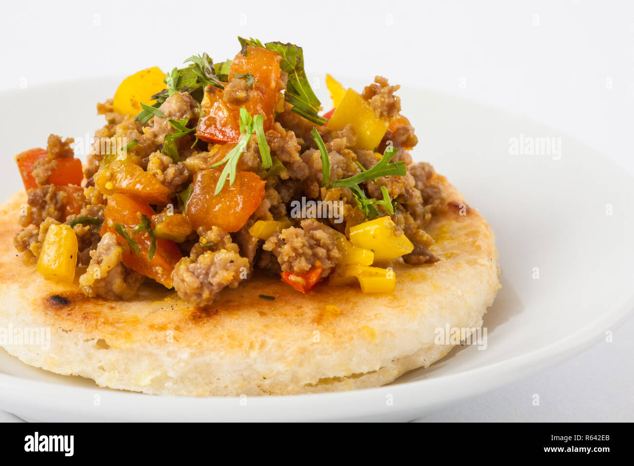 Traditional Colombian arepa topped with ground beef Stock Photo - Alamy