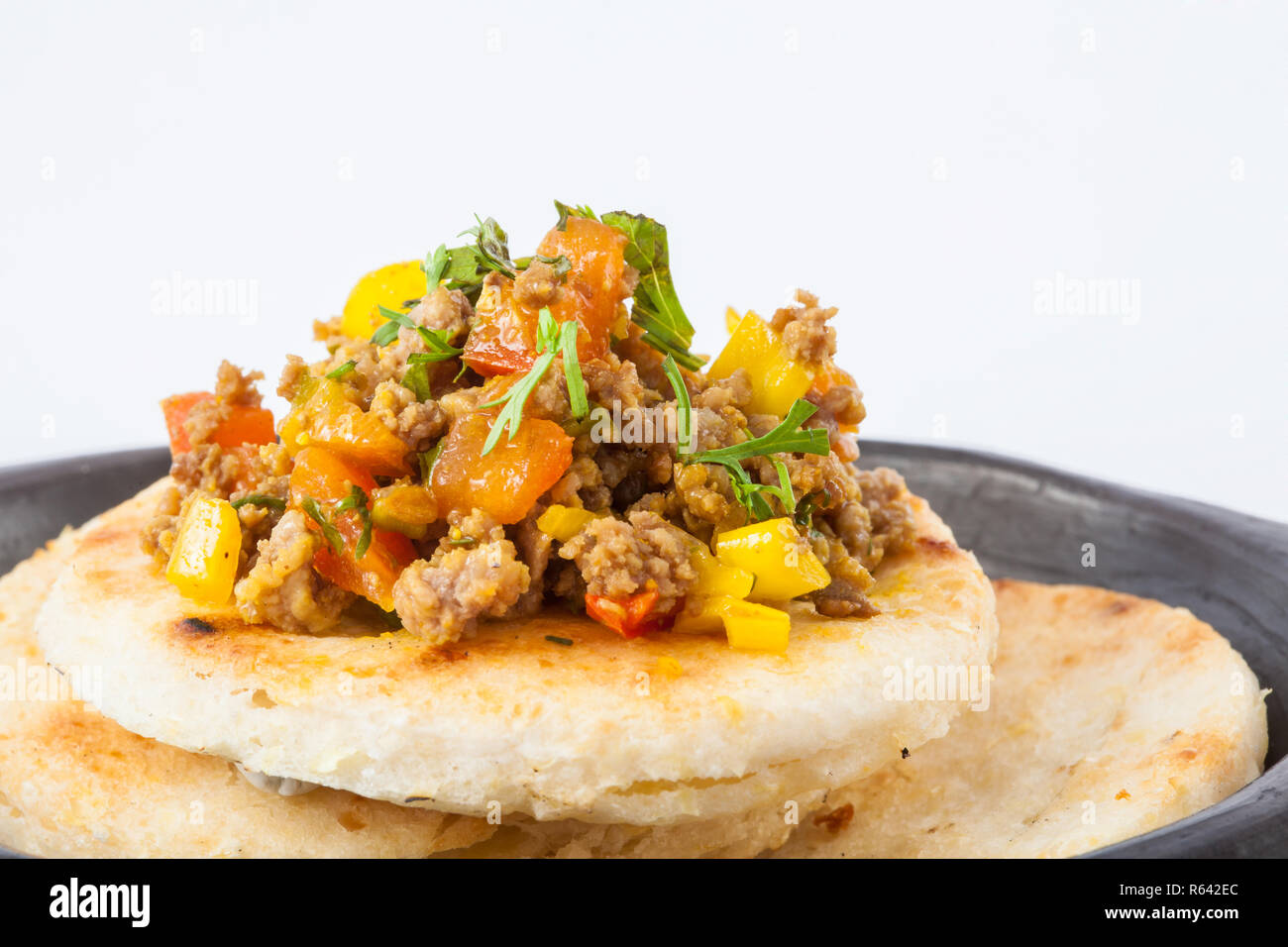 Traditional Colombian arepa topped with ground beef Stock Photo - Alamy