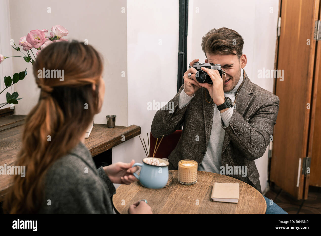 Man is taking a picture of woman using film camera Stock Photo - Alamy