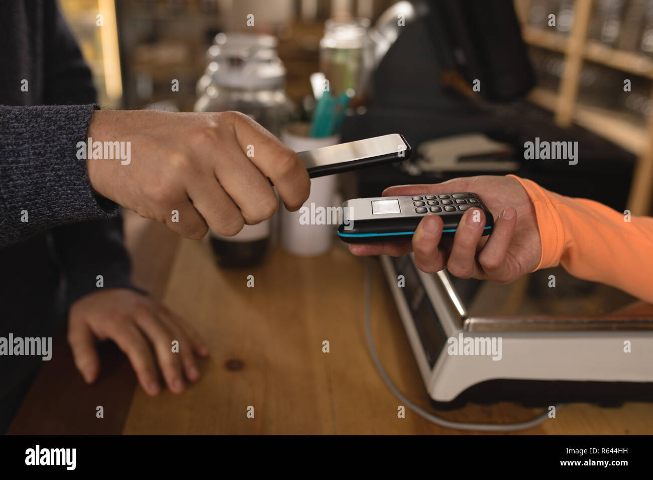 Customer making payment at counter in supermarket Stock Photo - Alamy