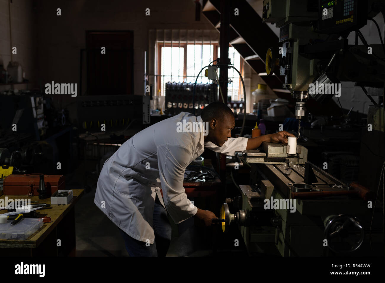 Male worker working in glass factory Stock Photo - Alamy