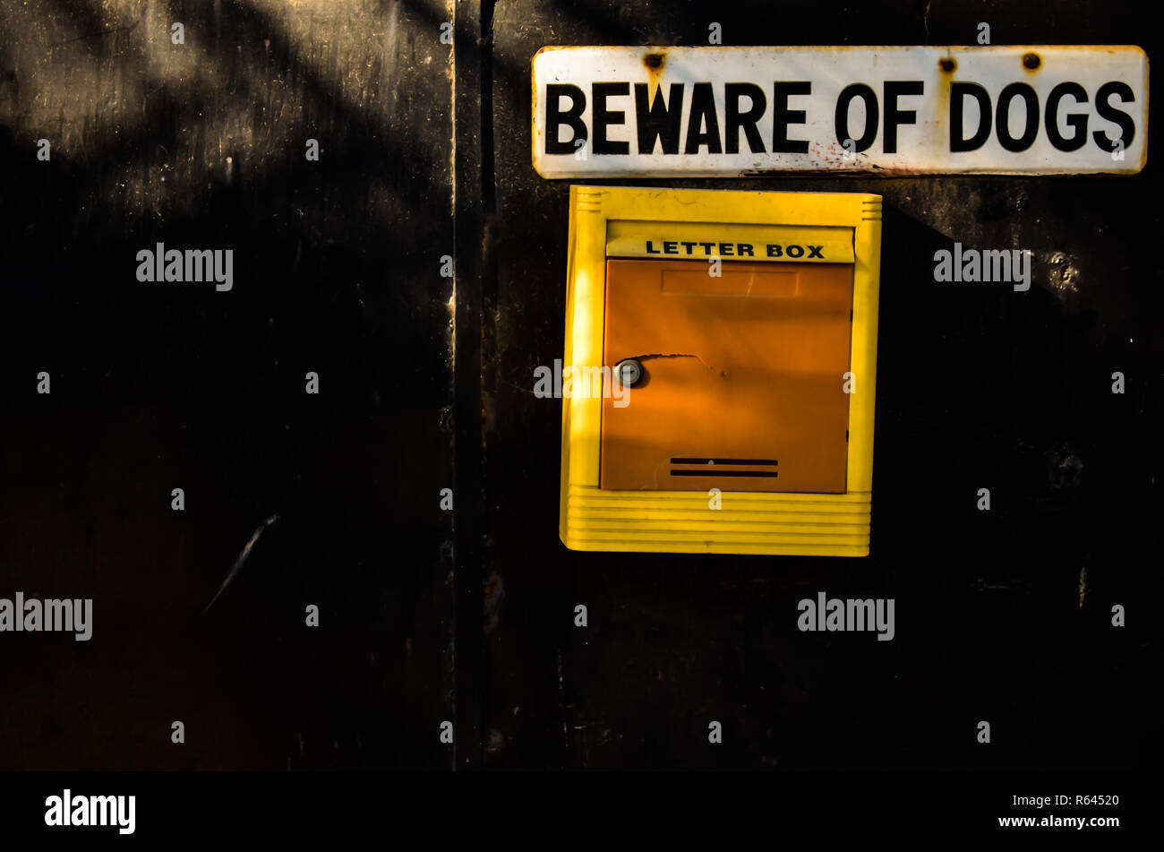 The photo also shows a yellow letter box below the funny sign on a ...