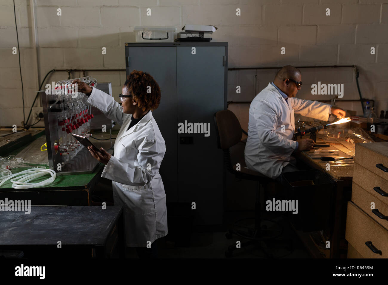 Workers working in glass factory Stock Photo - Alamy