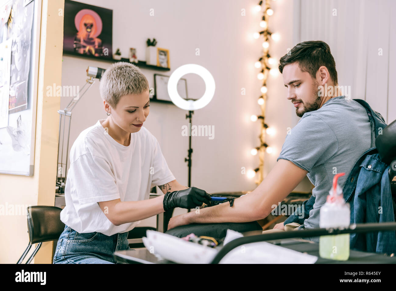 Extraordinary short-haired tattoo master shaving off hair from hand ...