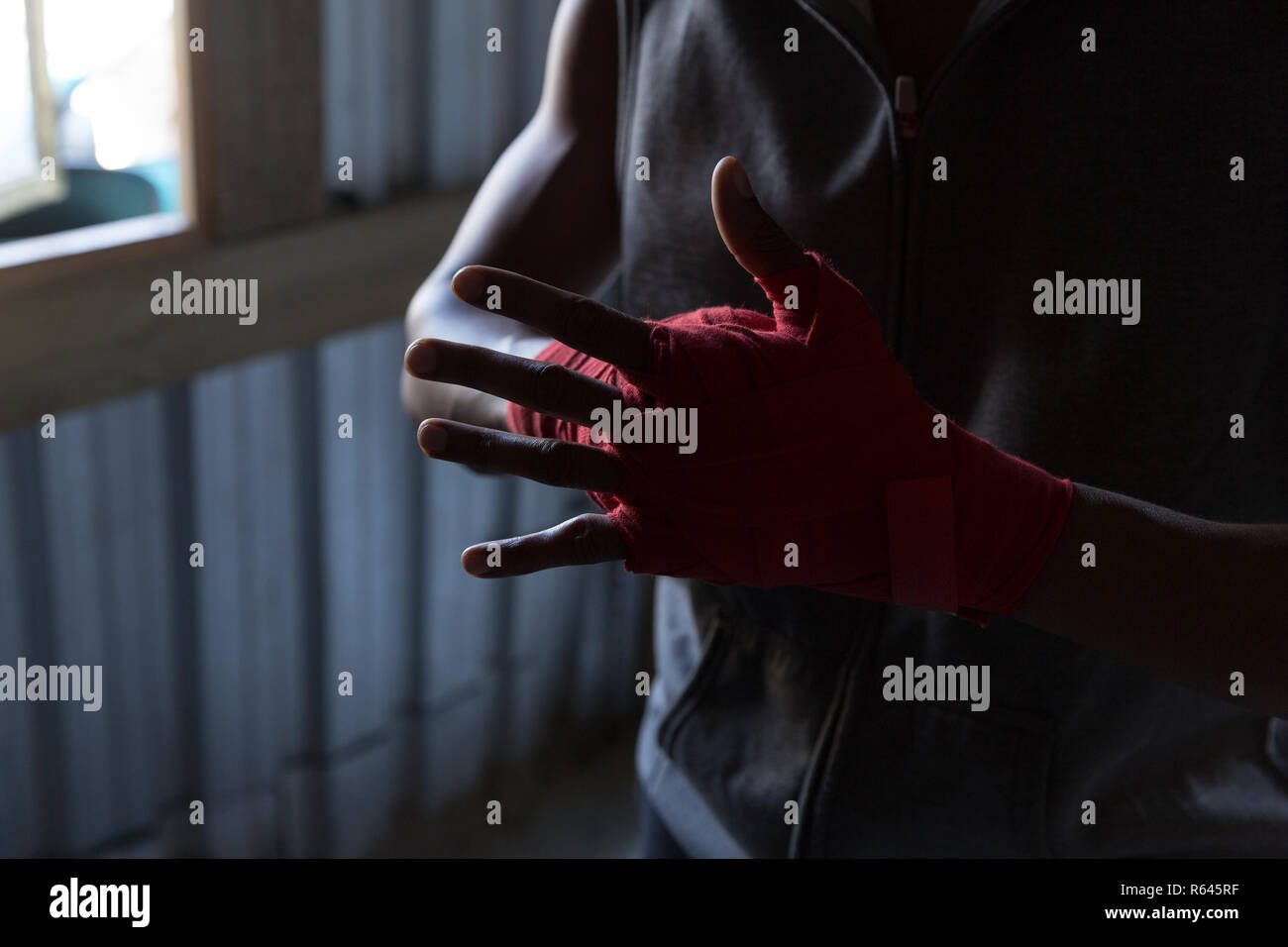 Male boxer tying hand wrap on hand in boxing club Stock Photo - Alamy
