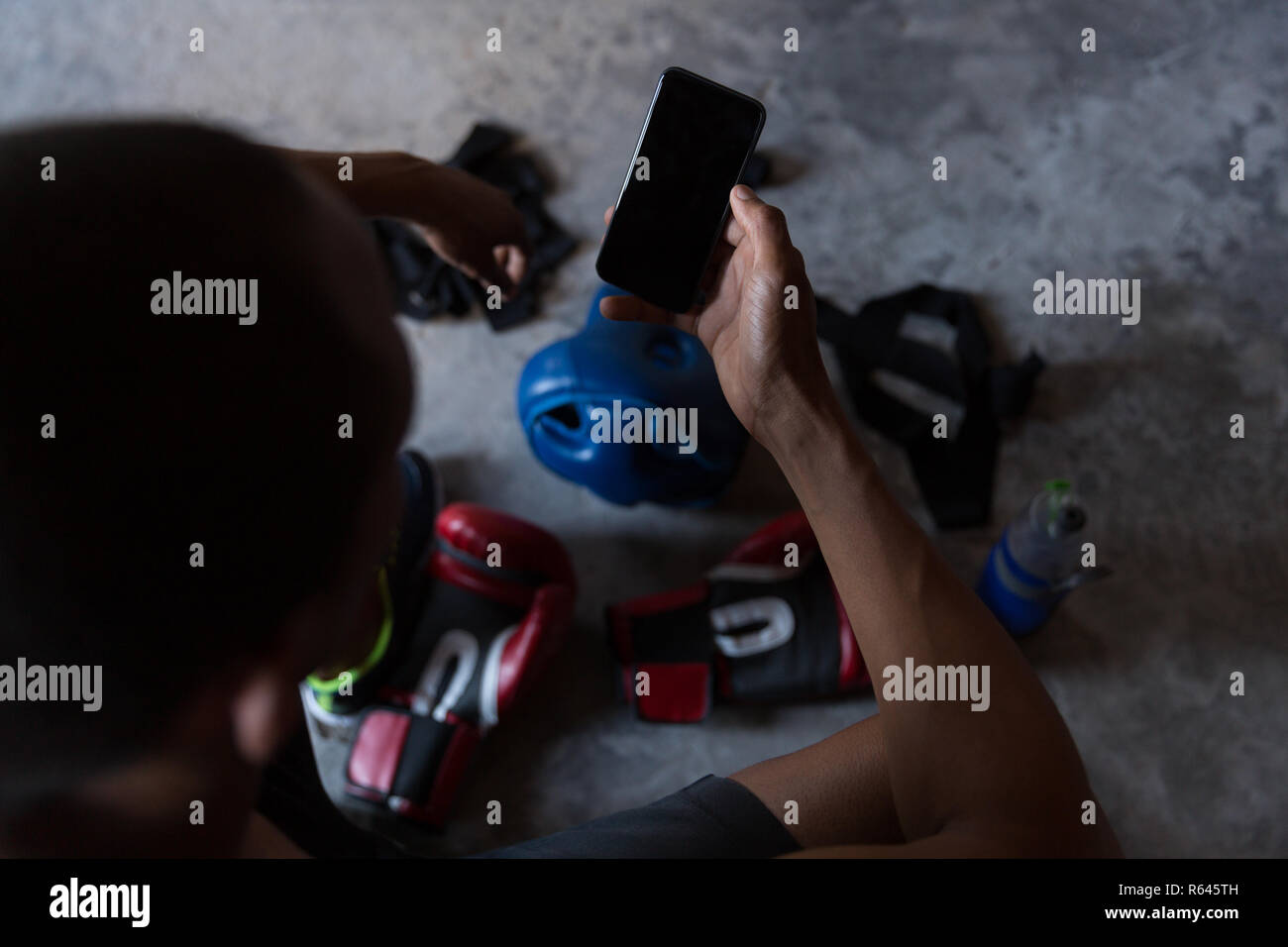 Male boxer using mobile phone in boxing club Stock Photo - Alamy