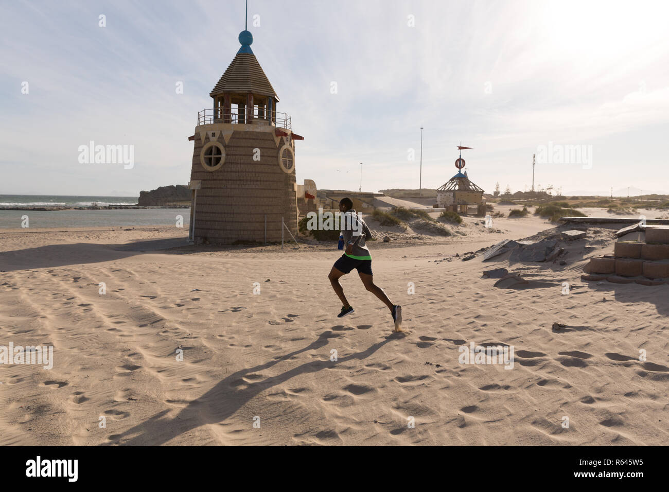 Black man jogging beach hi-res stock photography and images - Alamy