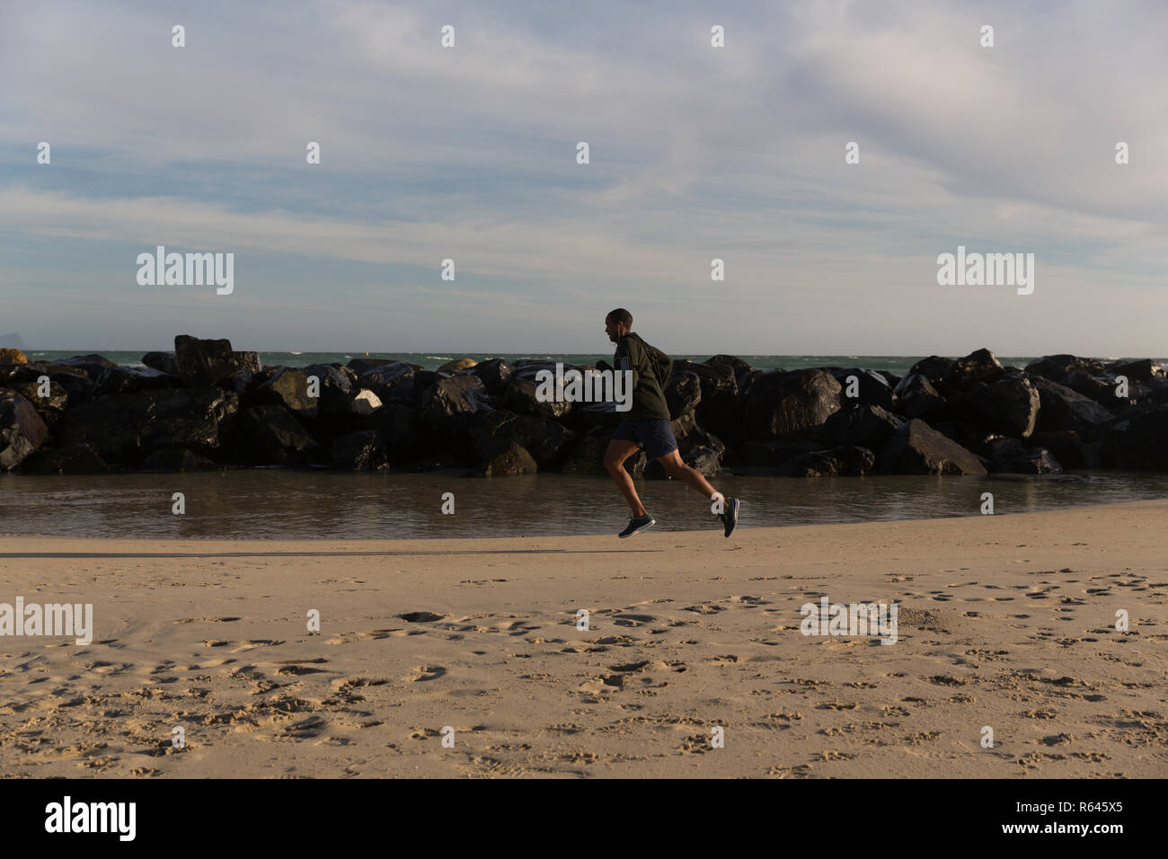 Male athlete jogging near beach Stock Photo - Alamy