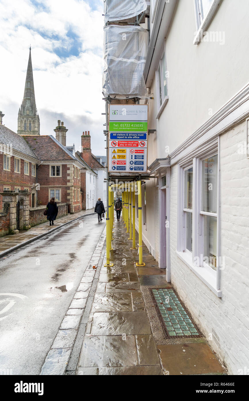 Scaffolding and construction site safety sign above wet pavement Stock ...