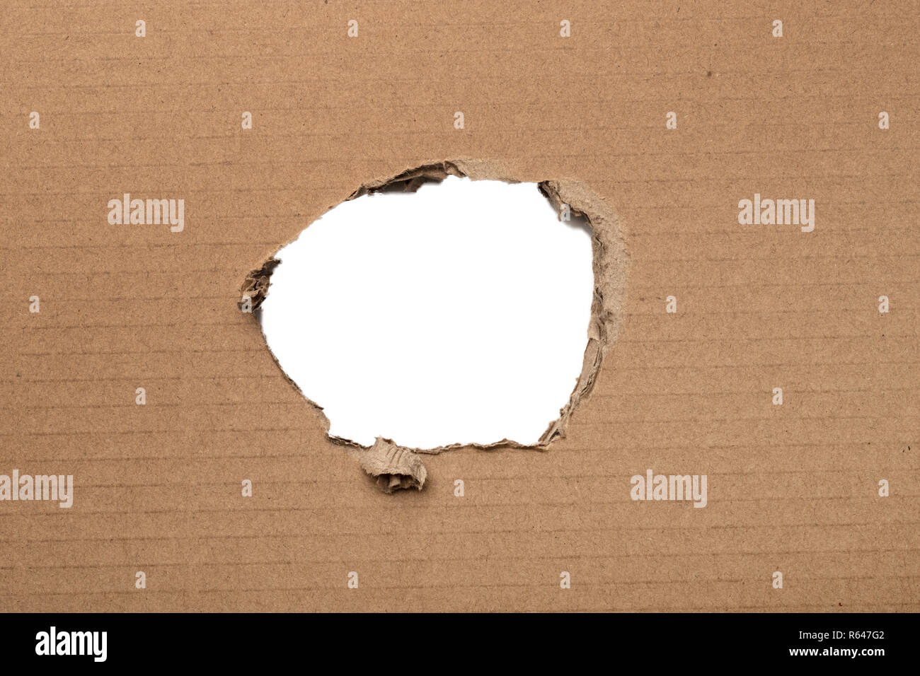 Ripped hole in brown cardboard isolated on white Stock Photo - Alamy