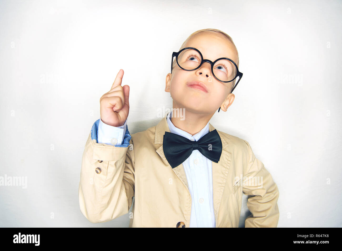 Cute little blonde boy dressed like a professor wearing a suit, bowtie ...