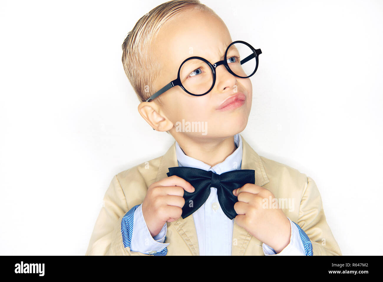 Cute little blonde boy dressed like a professor looking deep in thought ...