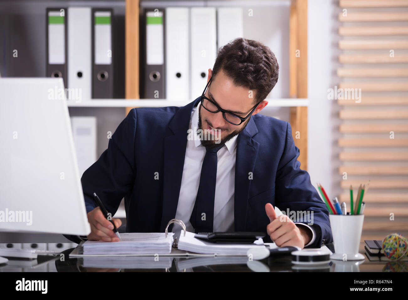 Businessman Calculating Bill Stock Photo - Alamy