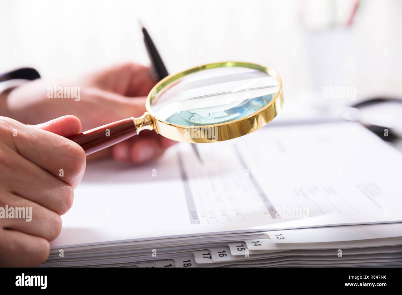 Businessperson Checking Bill With Magnifying Glass Stock Photo - Alamy