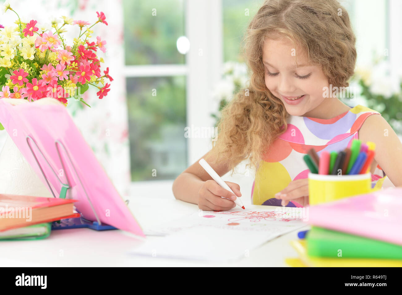 Portrait of cute schoolgirl doing homework in her room Stock Photo - Alamy