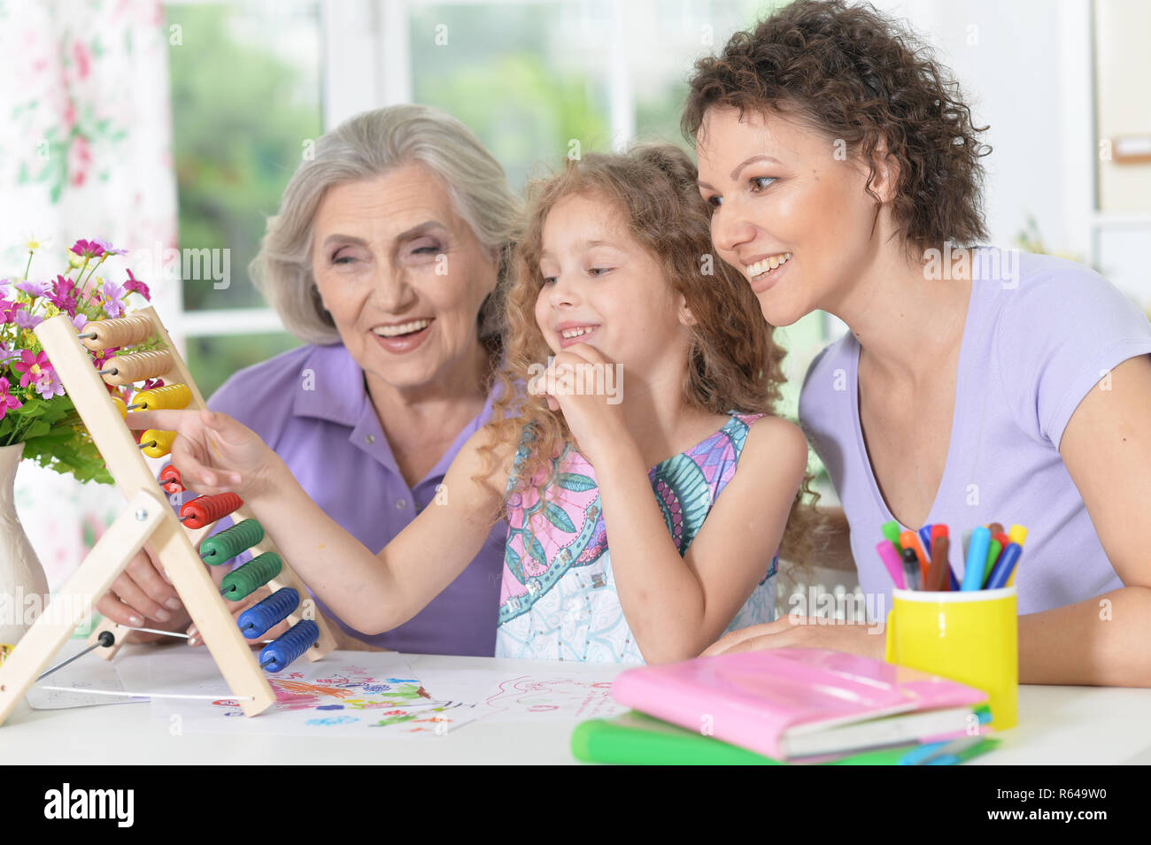 Portrait of cute happy family doing homework Stock Photo - Alamy
