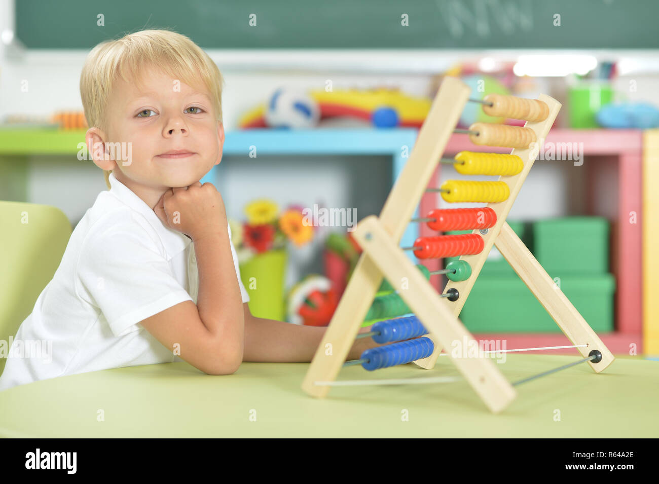 Little boy sitting and learning to use abacus Stock Photo - Alamy