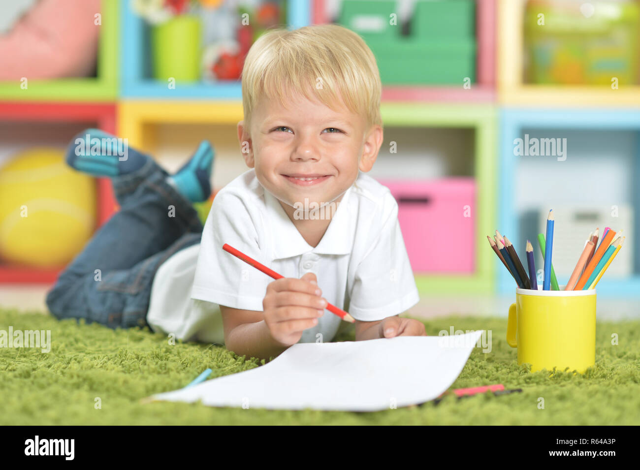Portrait of little boy drawing with pencils Stock Photo - Alamy