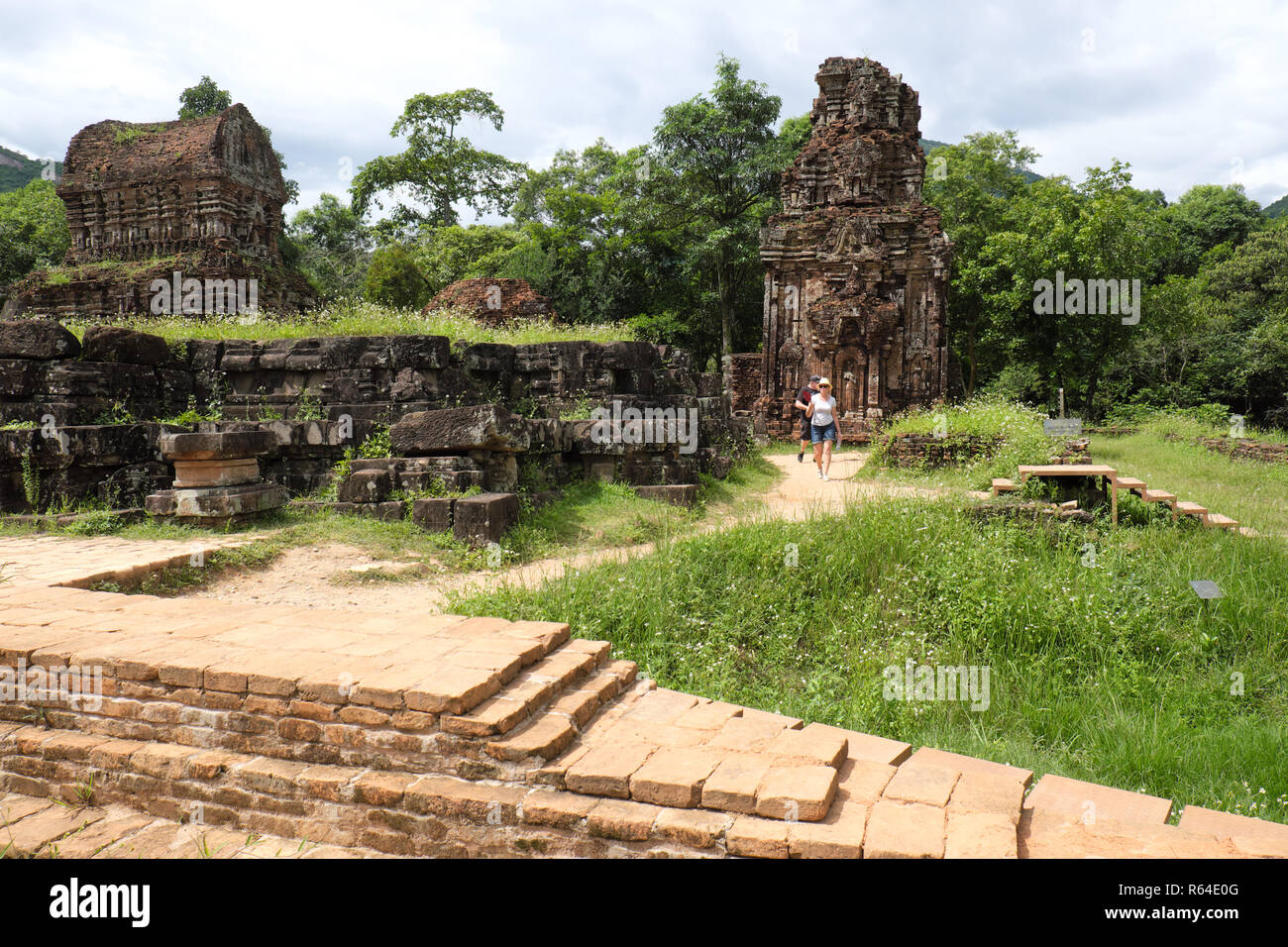 My Son Vietnam - tourists walk among the ruins of Hindu temples of the ...