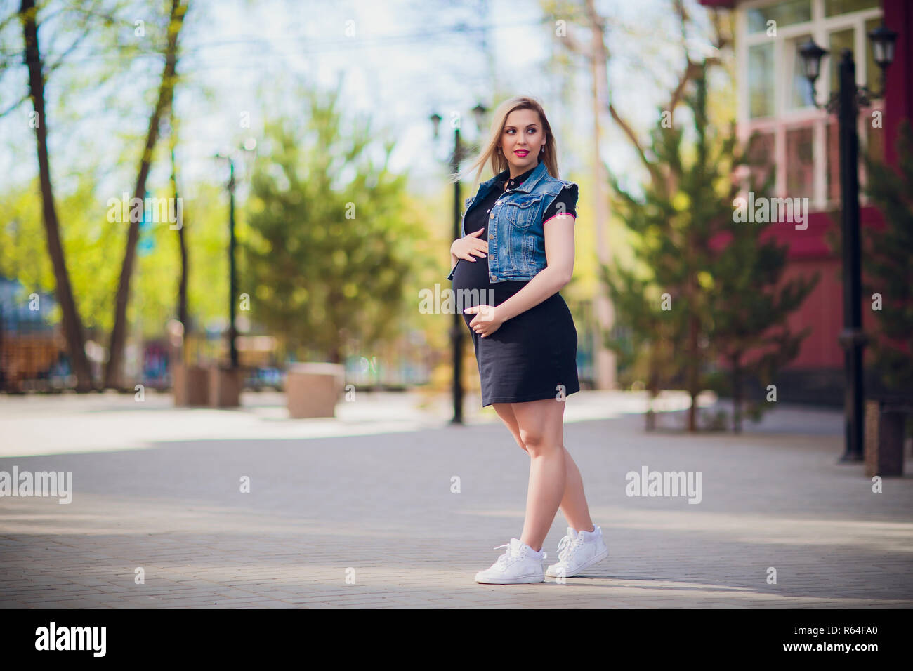 Young Pregnant Woman on Background Residential Building Stock Photo - Alamy