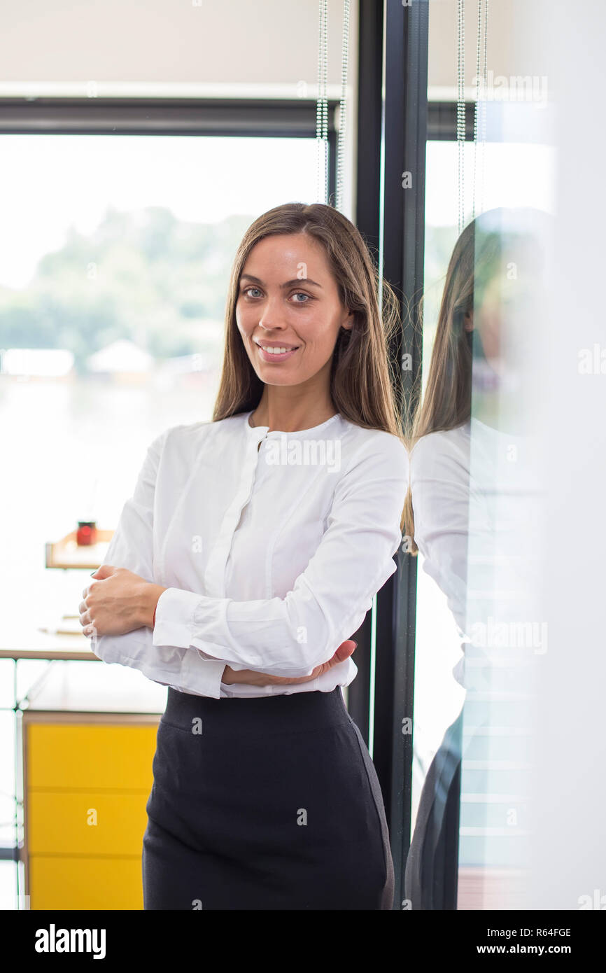 Young woman standing in the office Stock Photo - Alamy