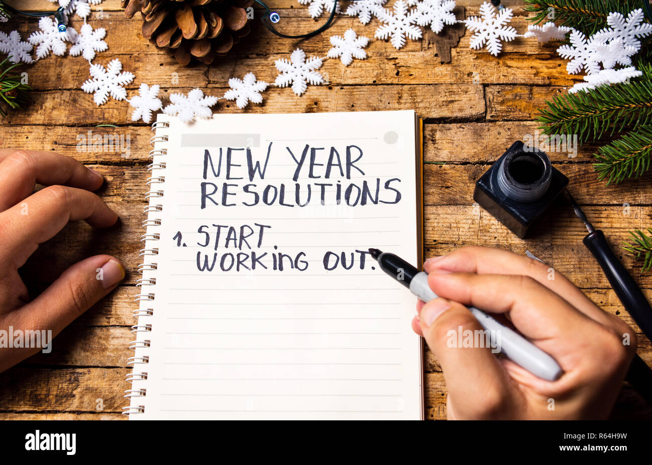 Person writing new year resolutions first person view Stock Photo - Alamy
