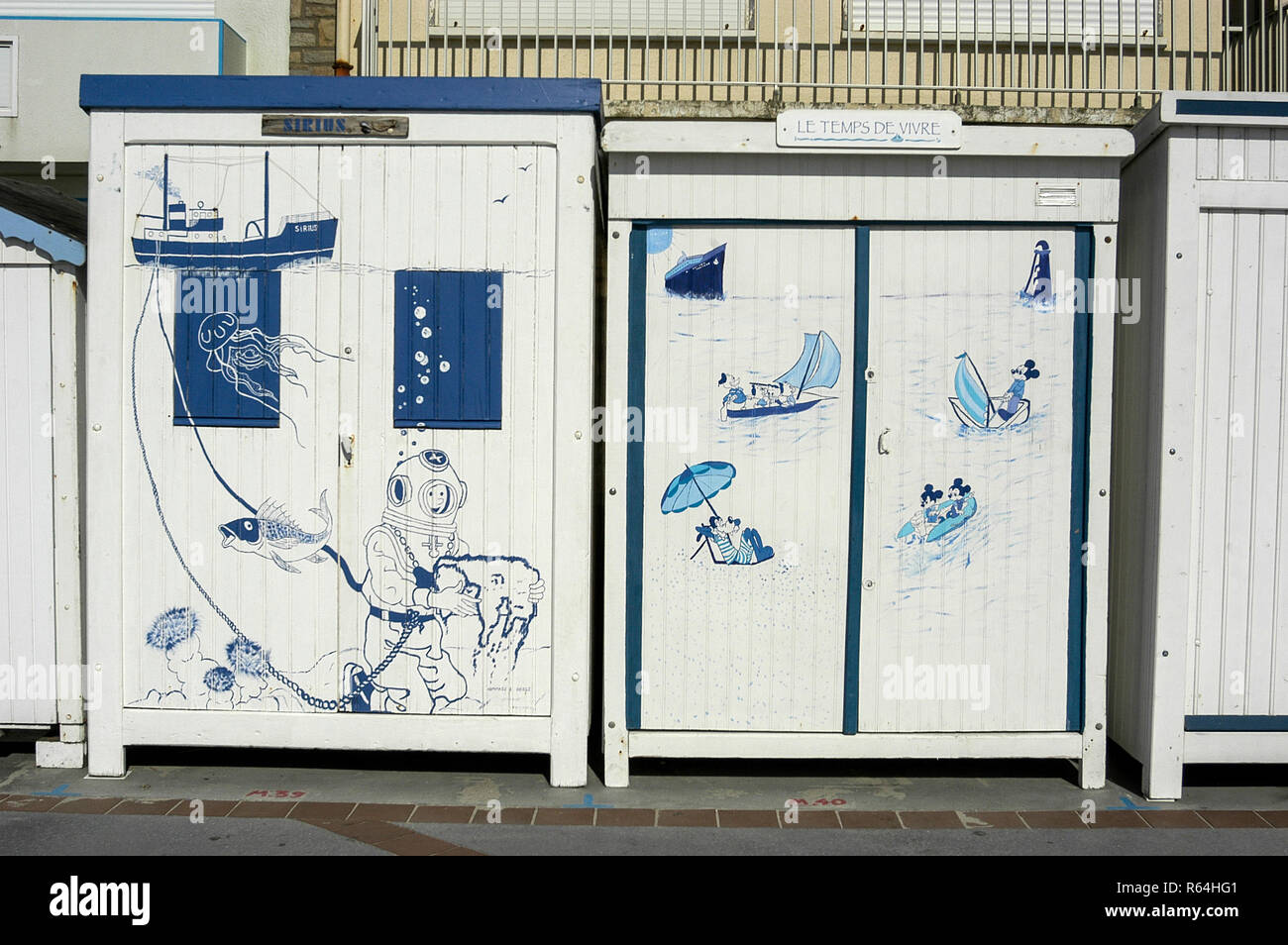 A row of seaside changing room huts along the sea facing promenade a ...