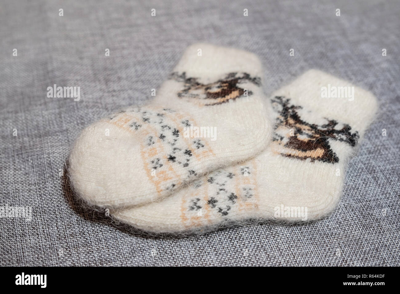 Baby wool socks on a light background close-up Stock Photo - Alamy