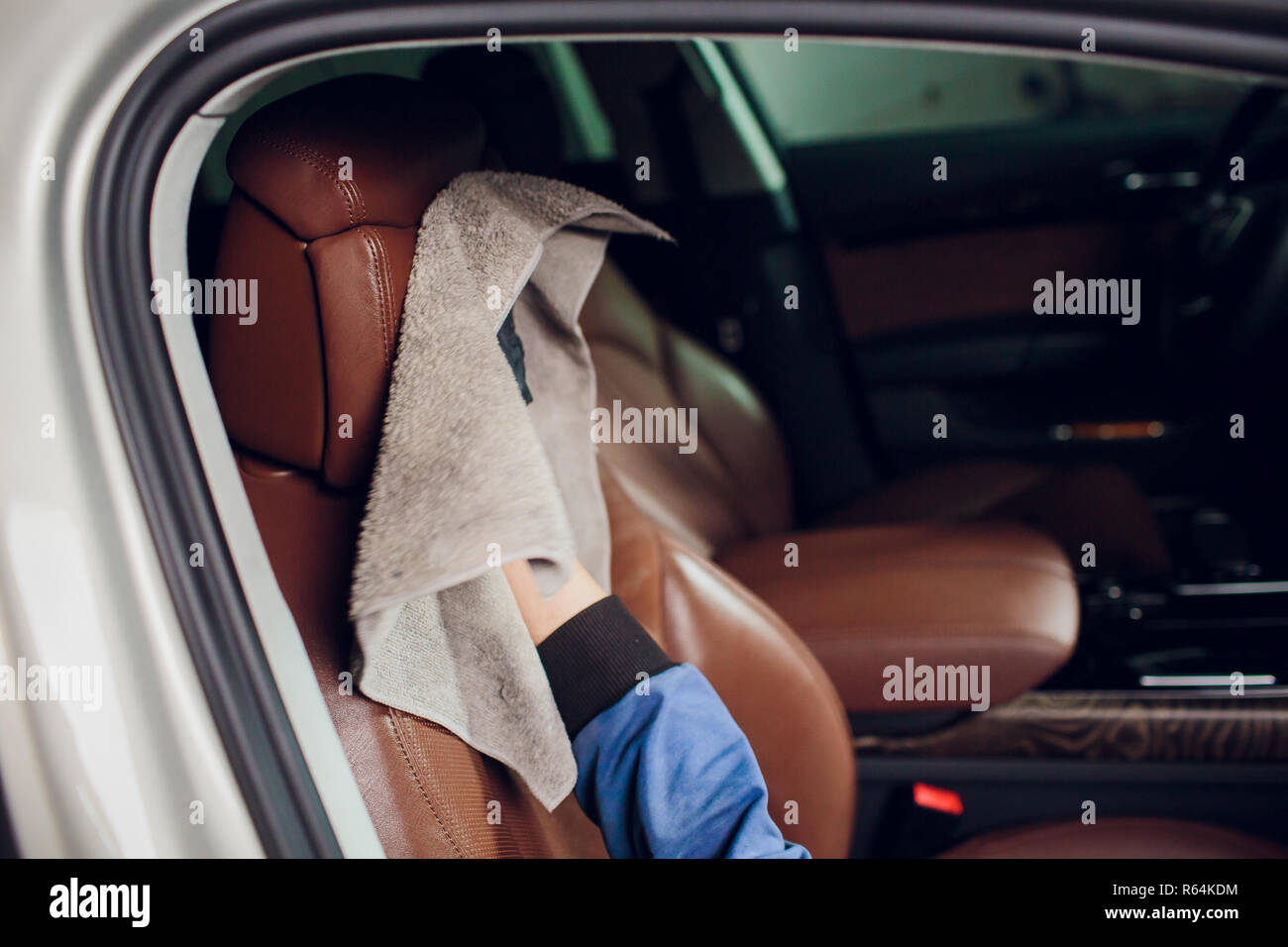 Auto service staff cleaning car interior detailing and valeting concept ...