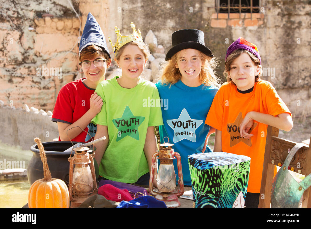Four friends pose by pumpkin Stock Photo - Alamy