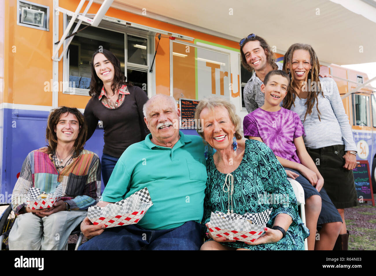 Elderly couple surrounded by diverse friends Stock Photo - Alamy