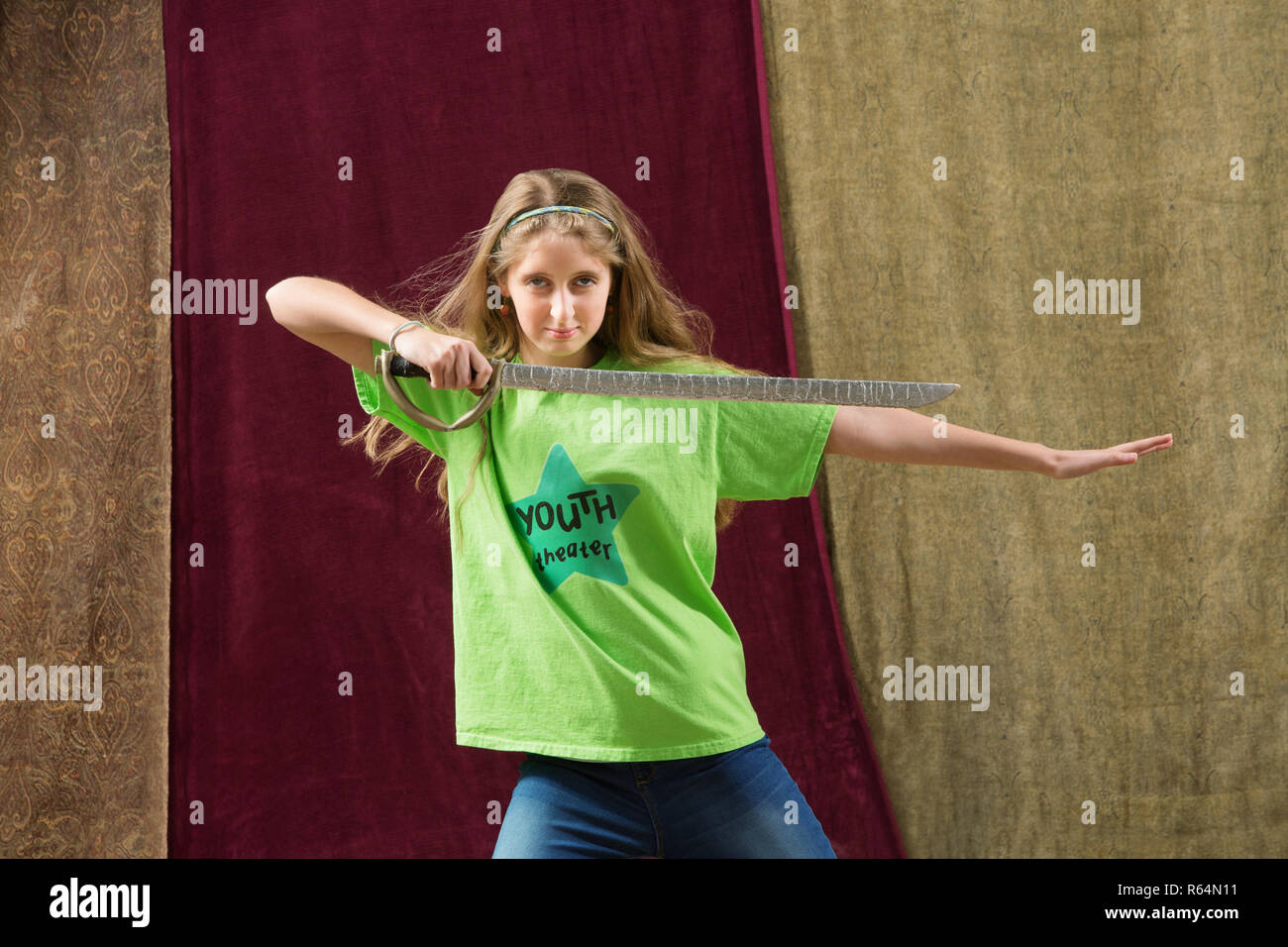 Girl holding sword poses for camera Stock Photo - Alamy