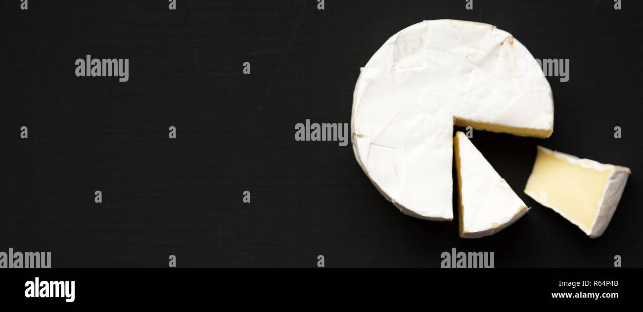 Cheese camembert or brie on dark black background. Milk production ...