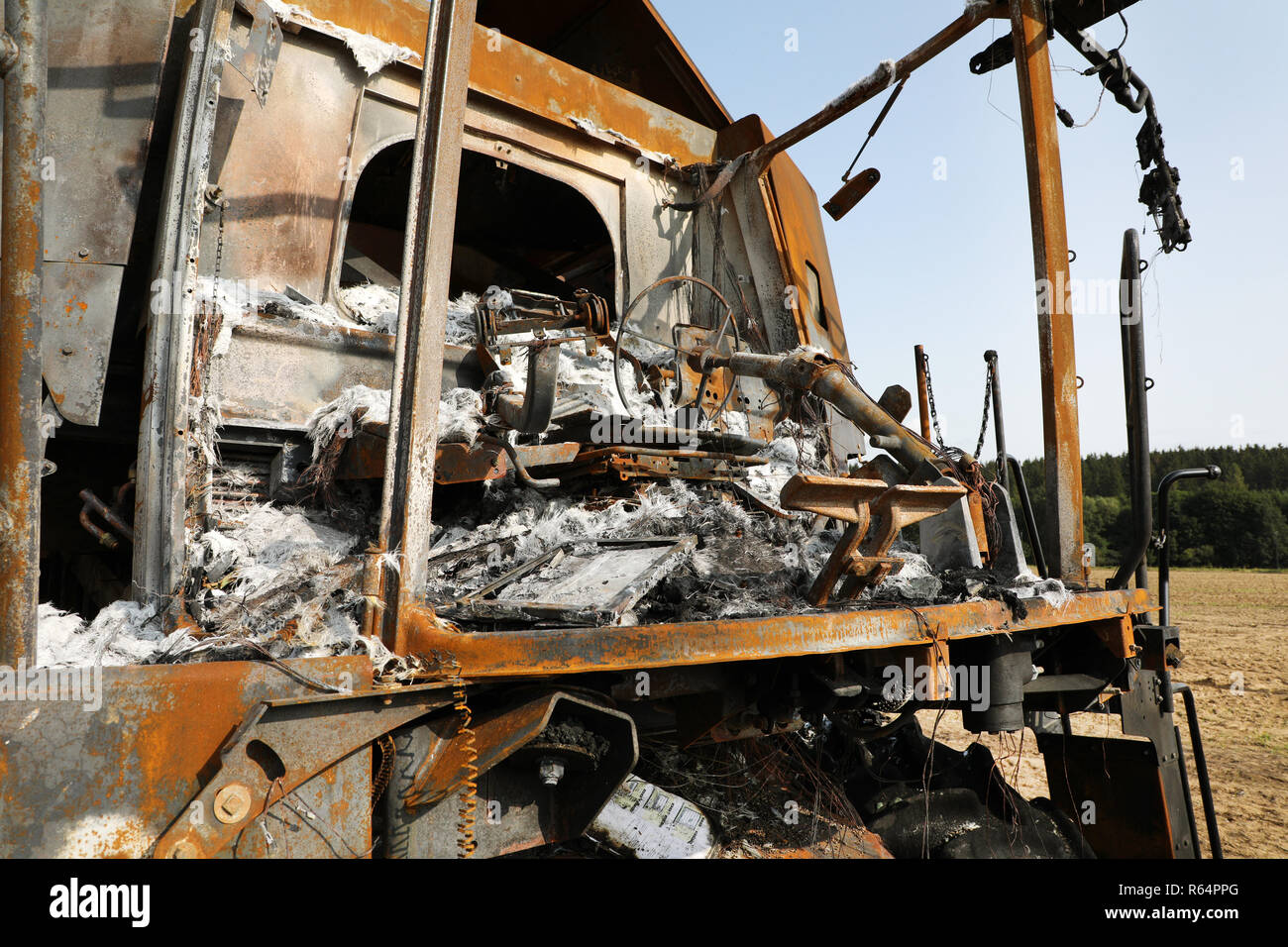 Combine harvester destroyed by fire Stock Photo - Alamy