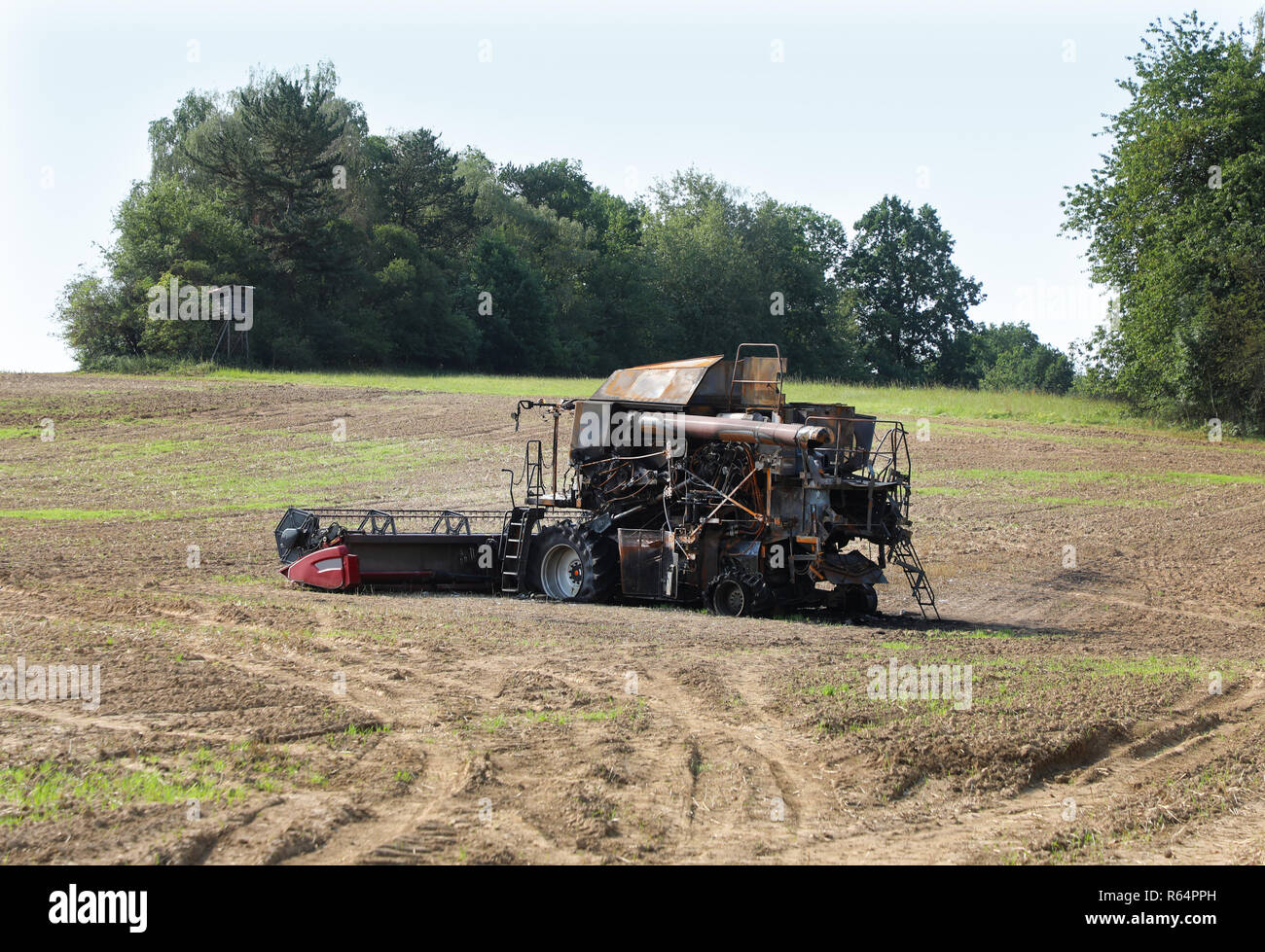 Combine harvester destroyed by fire Stock Photo - Alamy