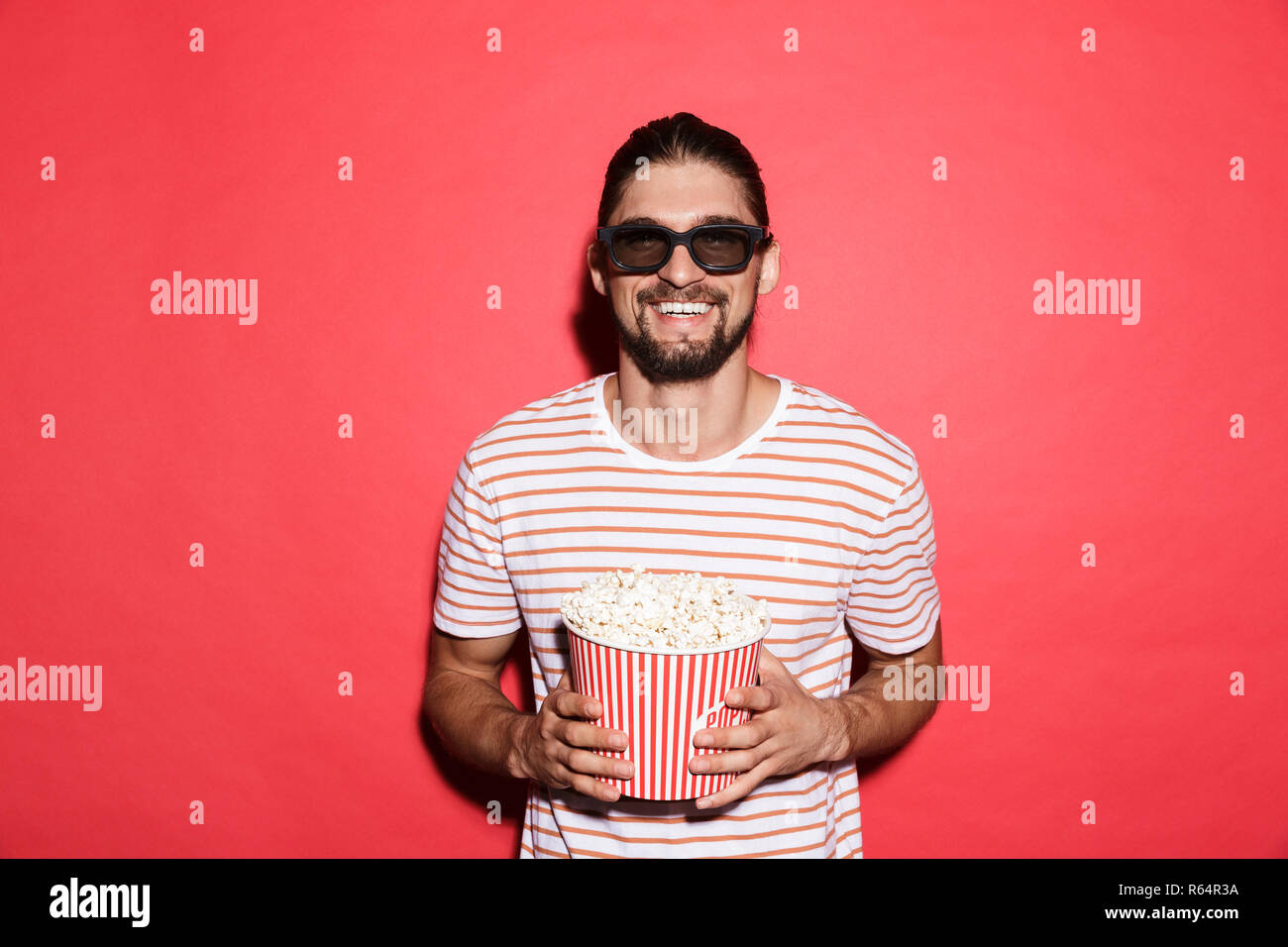 Laughing caucasian man eating popcorn High Resolution Stock Photography ...