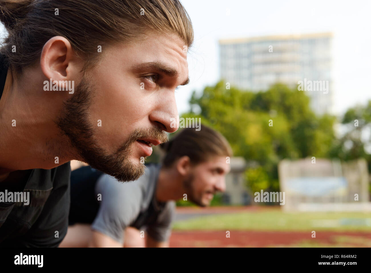 Photo of young two twins sportsmen brothers ready to run outdoors Stock ...