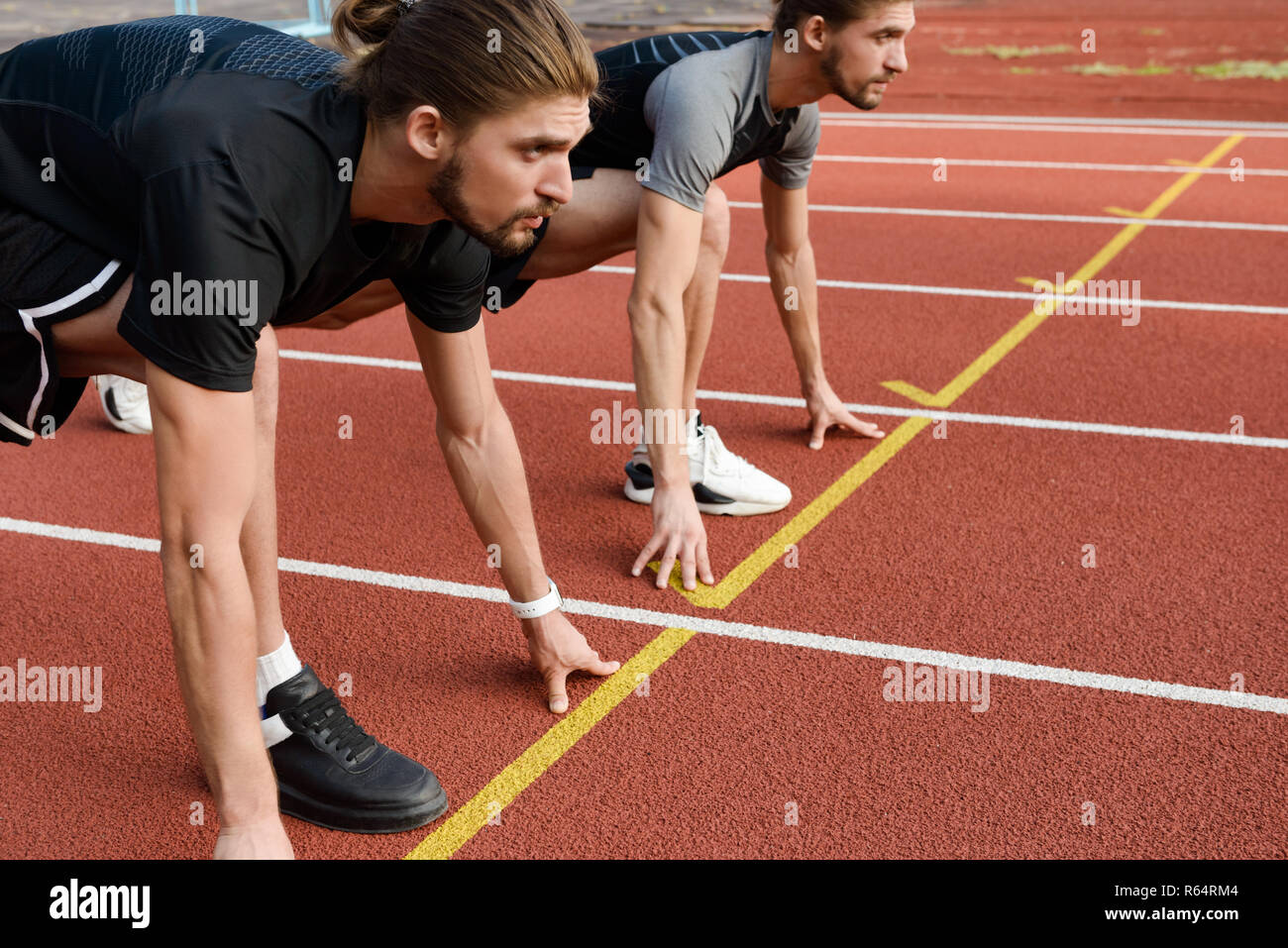 Photo of young two twins sportsmen brothers ready to run outdoors Stock ...