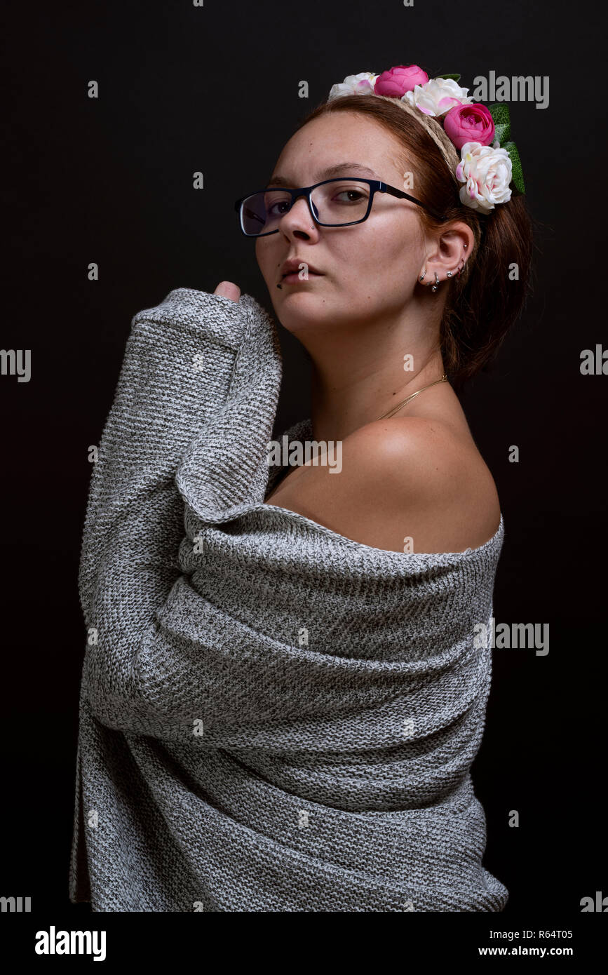 Portrait of woman wearing eye glasses and floral hand band while ...