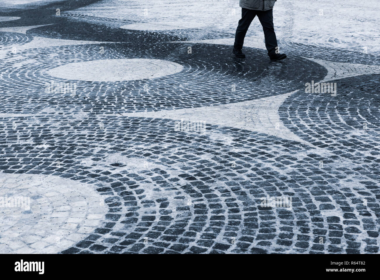 Cobblestone pavement in Winter with snow and passenger Stock Photo - Alamy
