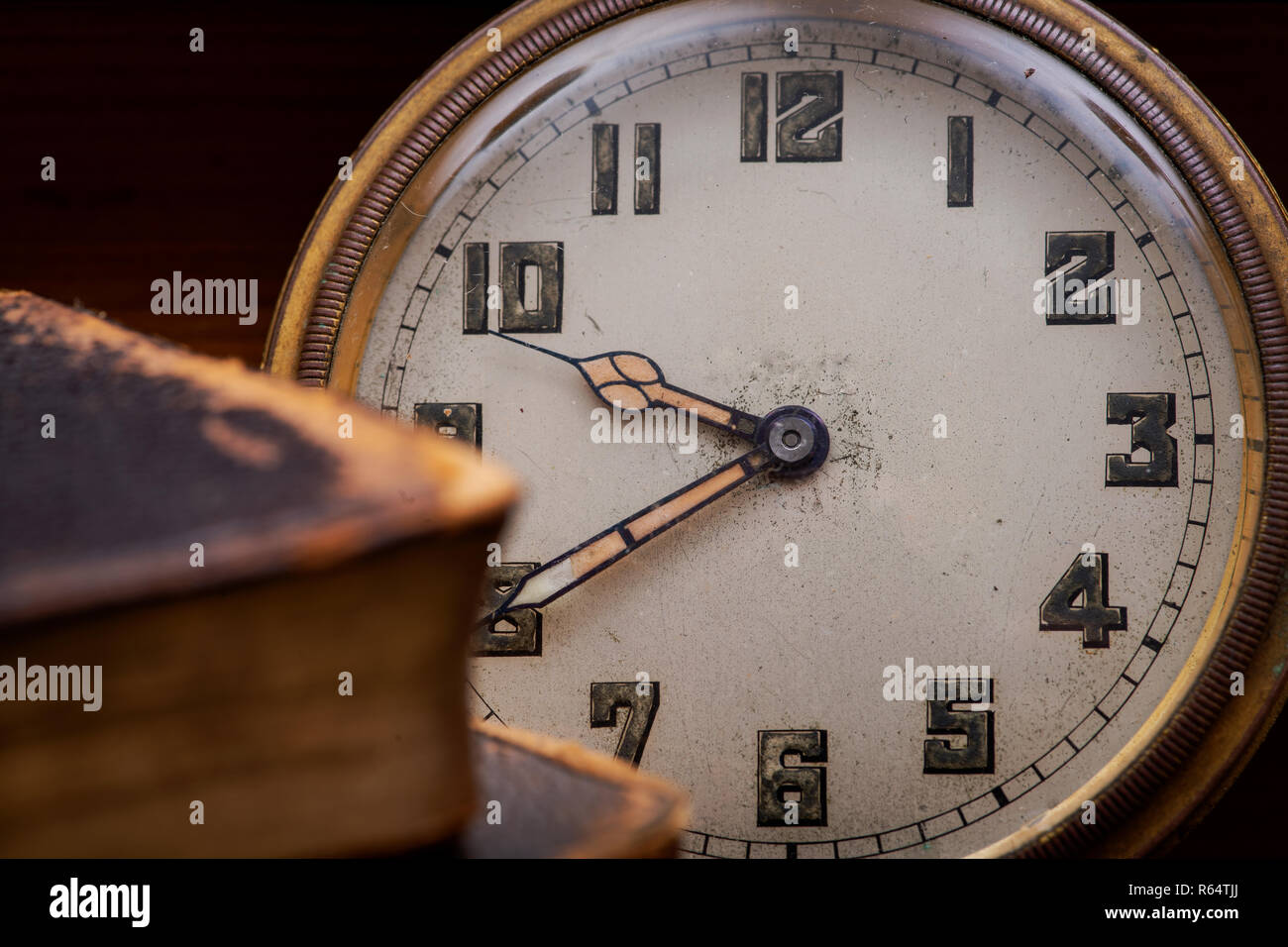 Panta rhei concept: antique pocket watch and pile of vintage hard cover ...