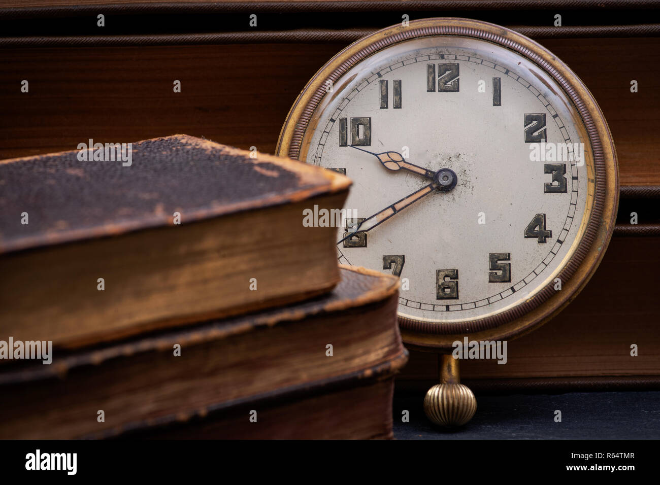 Panta rhei concept: antique pocket watch and pile of vintage hard cover ...