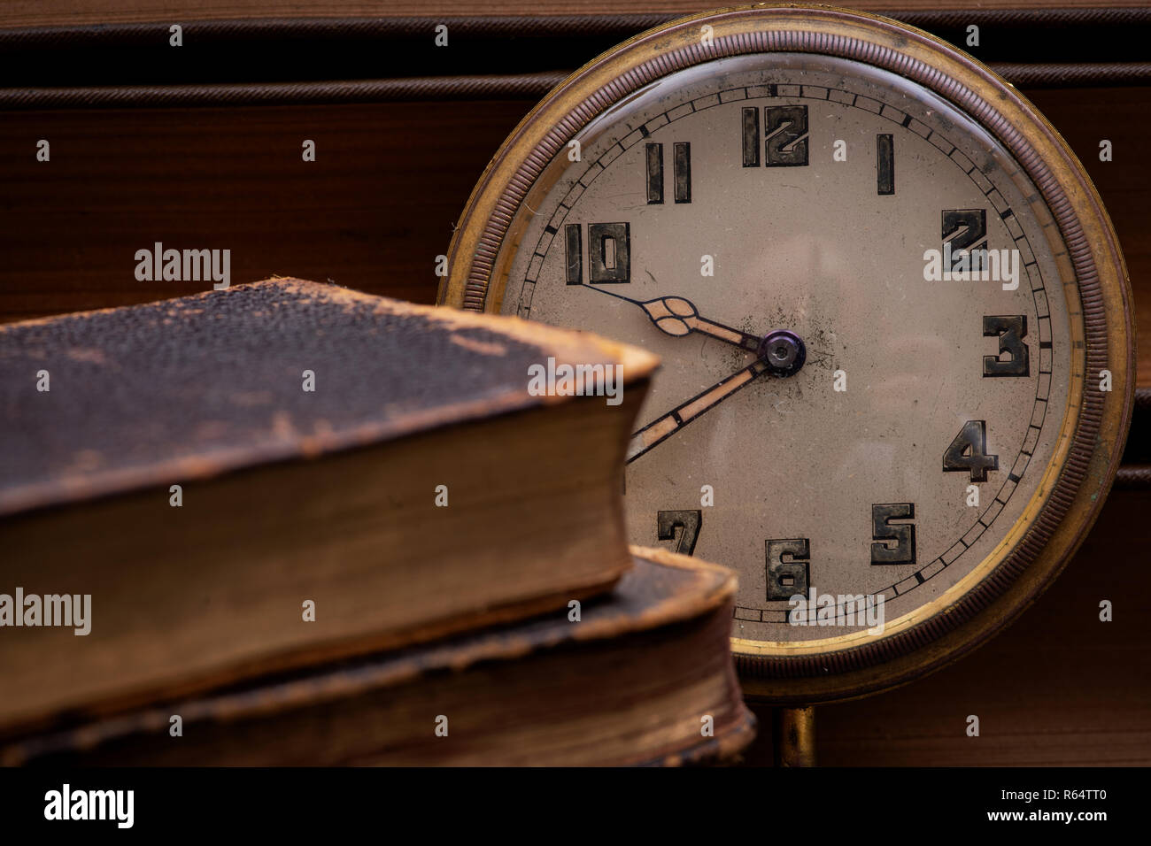 Panta rhei concept: antique pocket watch and pile of vintage hard cover ...