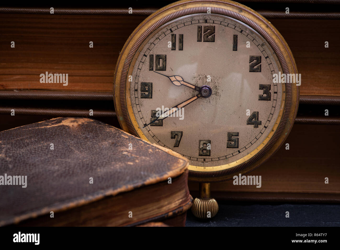 Panta rhei concept: antique pocket watch and pile of vintage hard cover ...