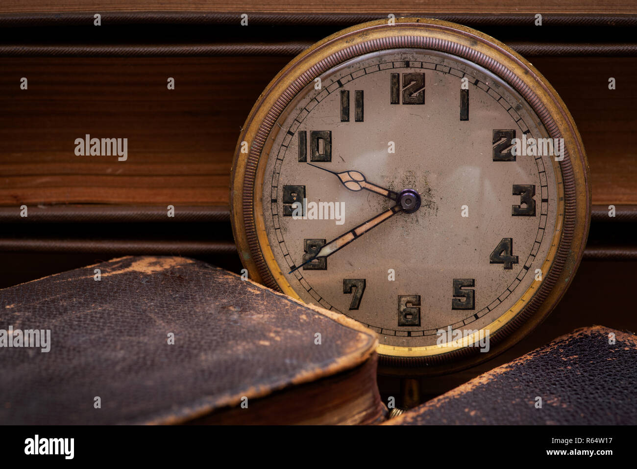 Panta rhei concept: antique pocket watch and pile of vintage hard cover ...